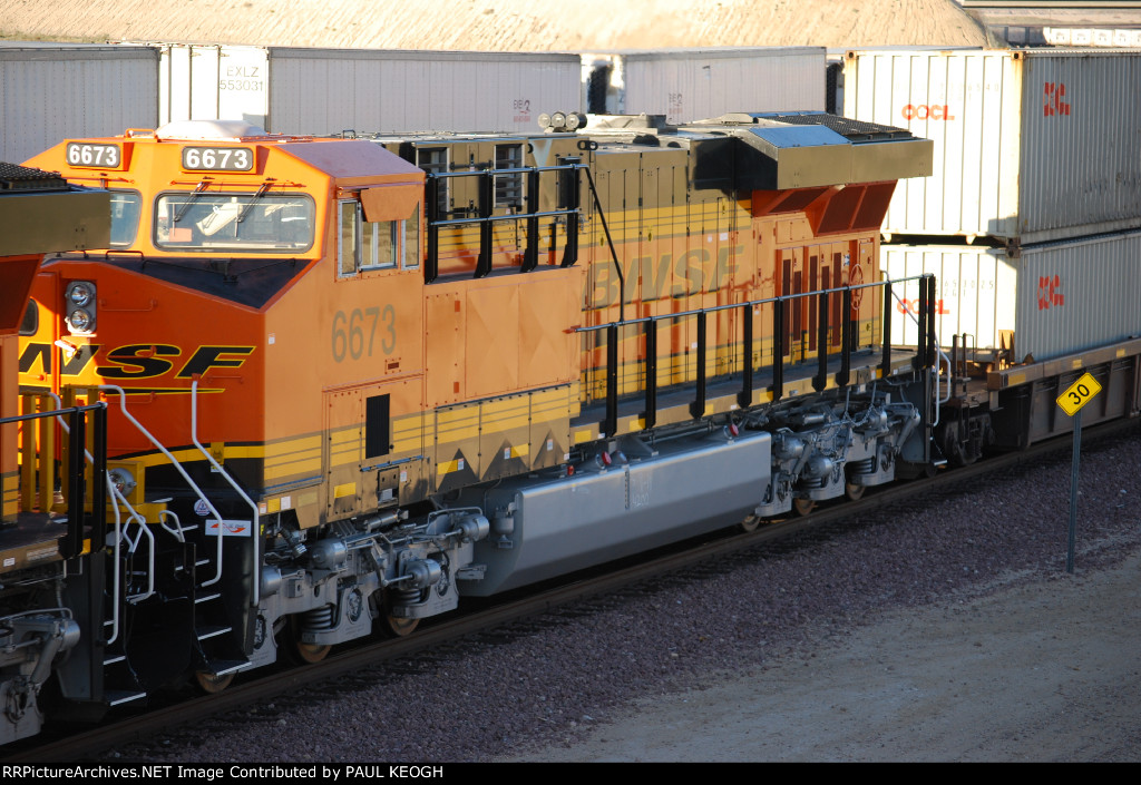 BNSF 6673 heads east pushing a Z-Train on her Return First Revenue Run as the Lead Rear DPU.